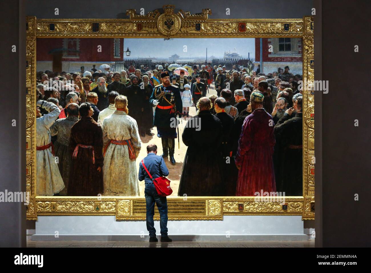 A visitor seen examining the artwork "Emperor Alexander III Receives ...