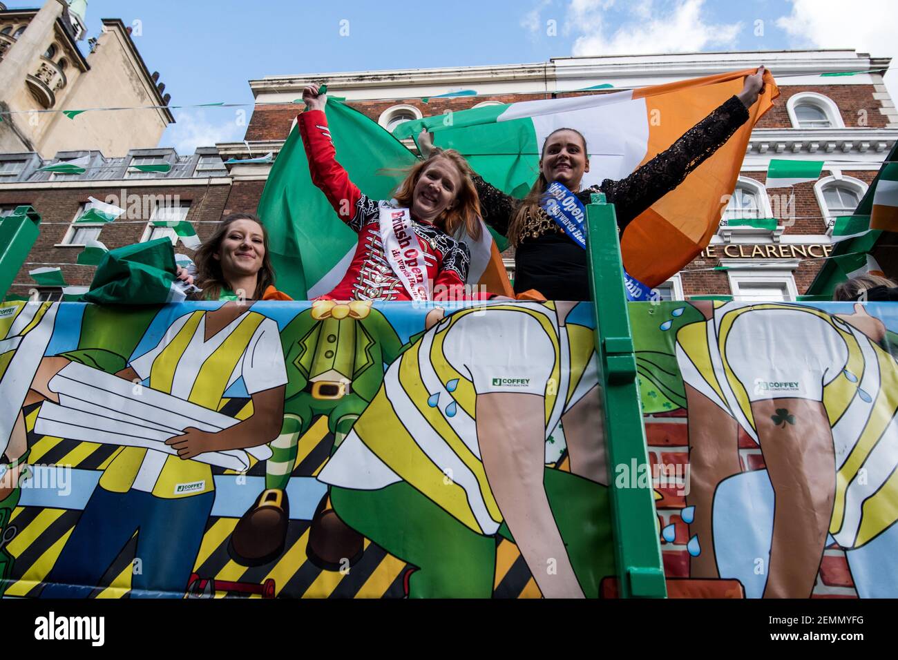 Women seen on a parade floats with iris flags during the parade. The ...