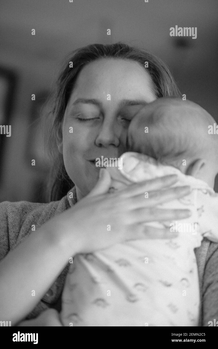 Mother hugging a baby Stock Photo - Alamy