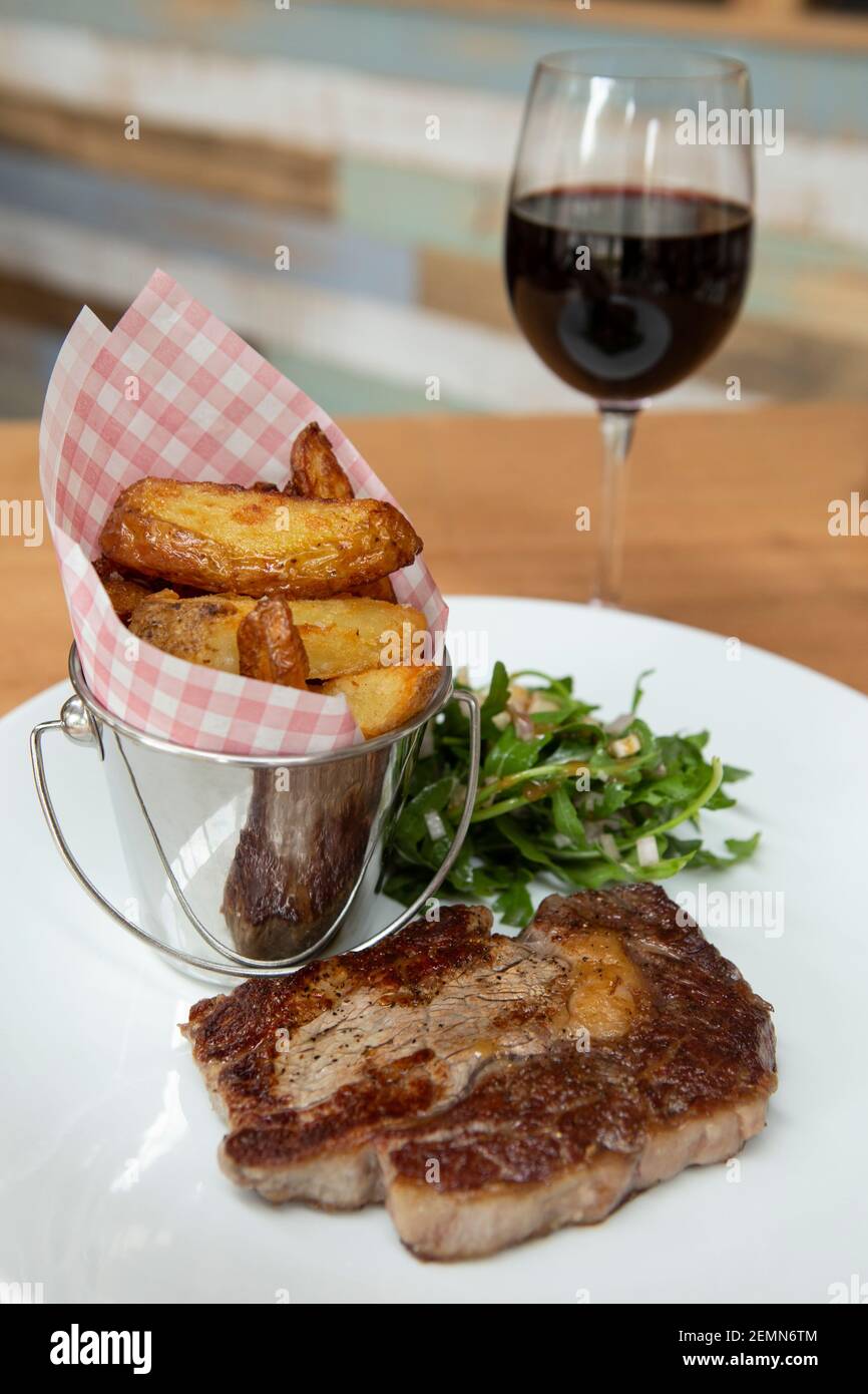 Steak and chips served with red wine Stock Photo - Alamy