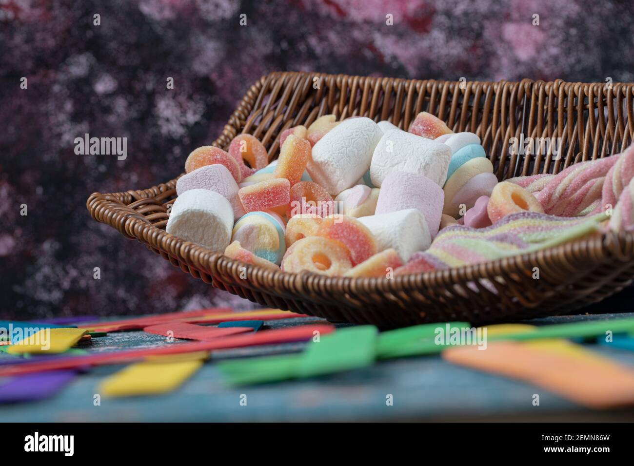 Multicolor marshmallow and jellybeans mix in a rustic basket Stock ...