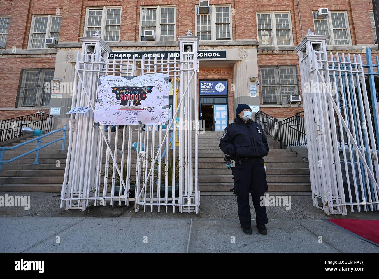 An NYPD School Safety officer stands outside of Richard R. Green Middle ...