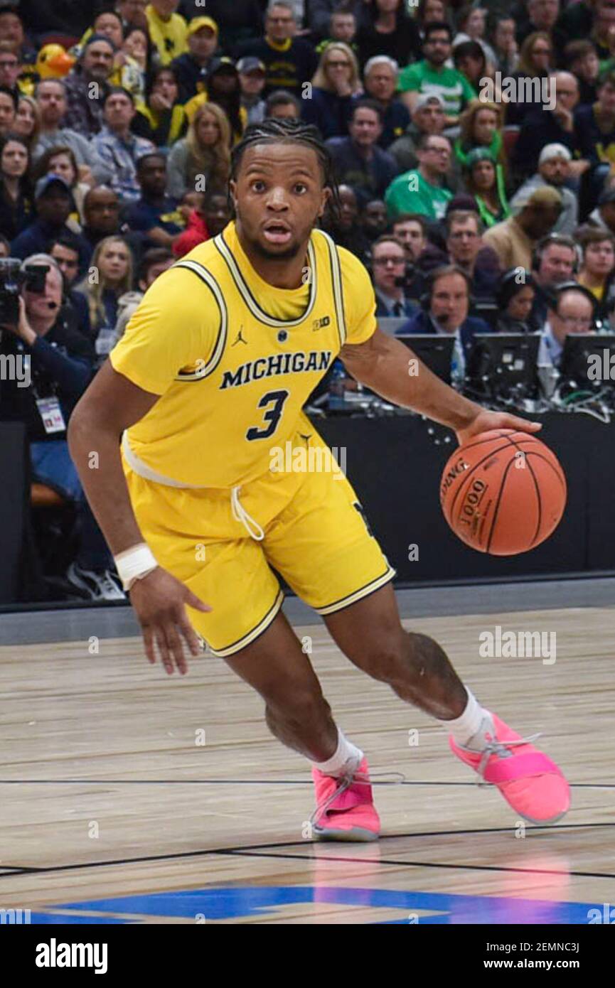 Zavier Simpson of the Michigan Wolverines drives to the basket during ...