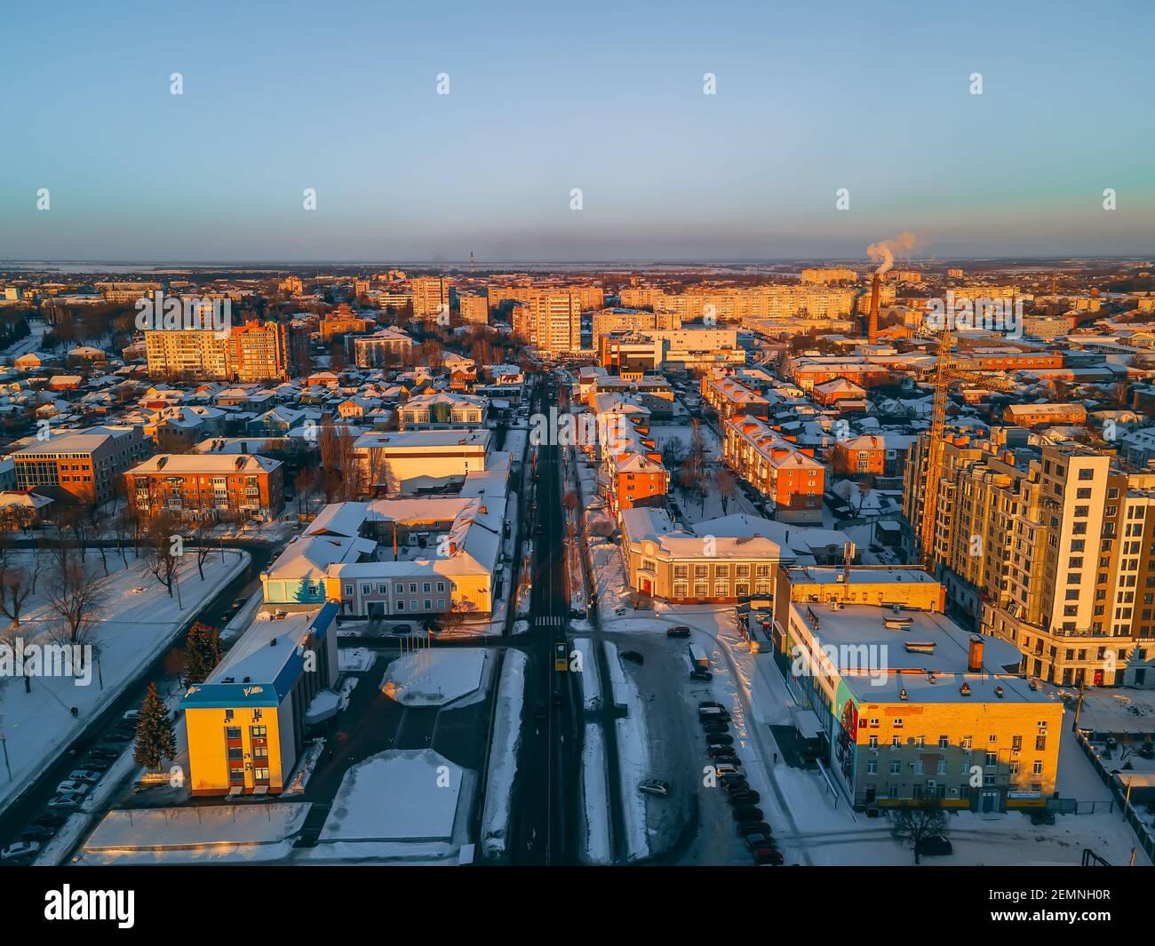 Aerial view of road in small european city with snow covered roofs at ...