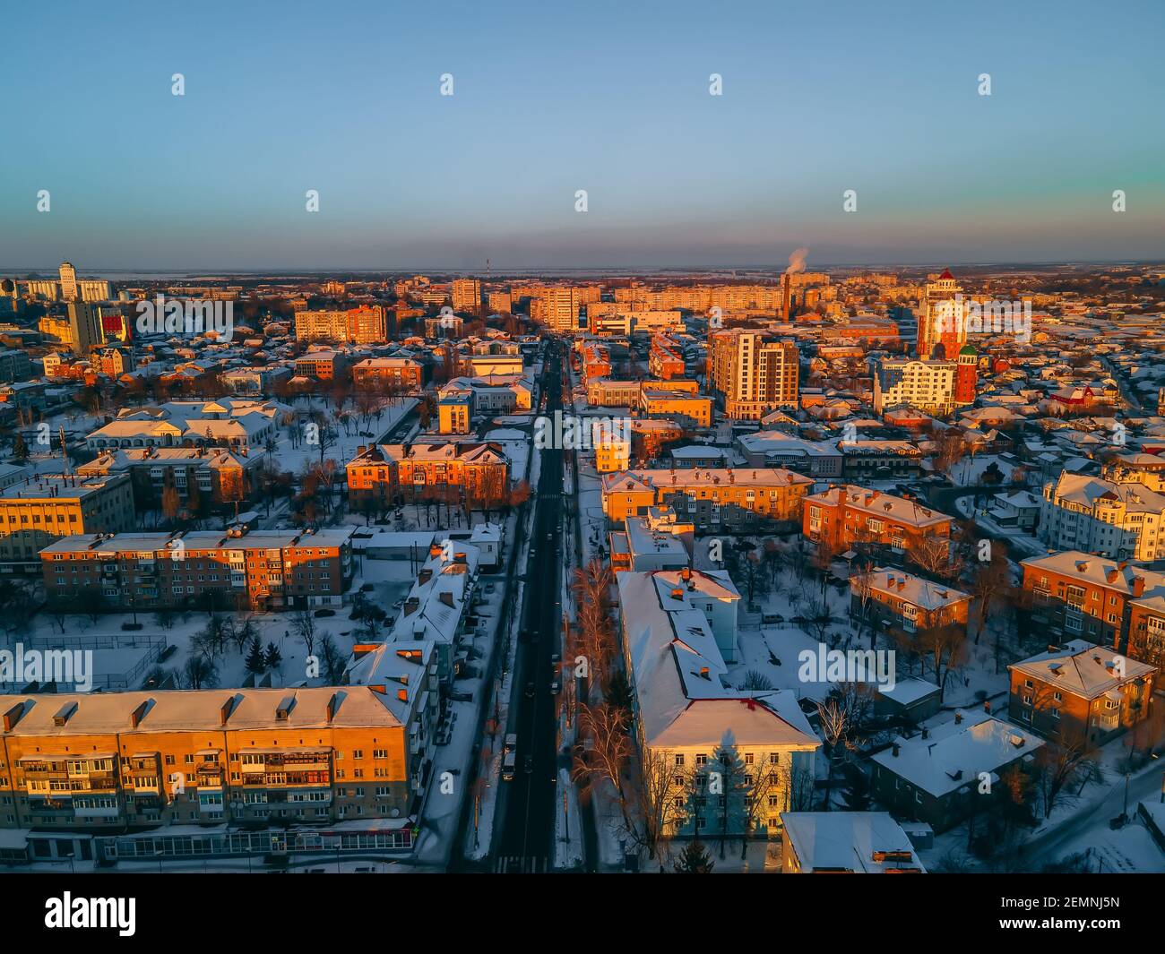 Aerial view of road in small european city with snow covered roofs at ...