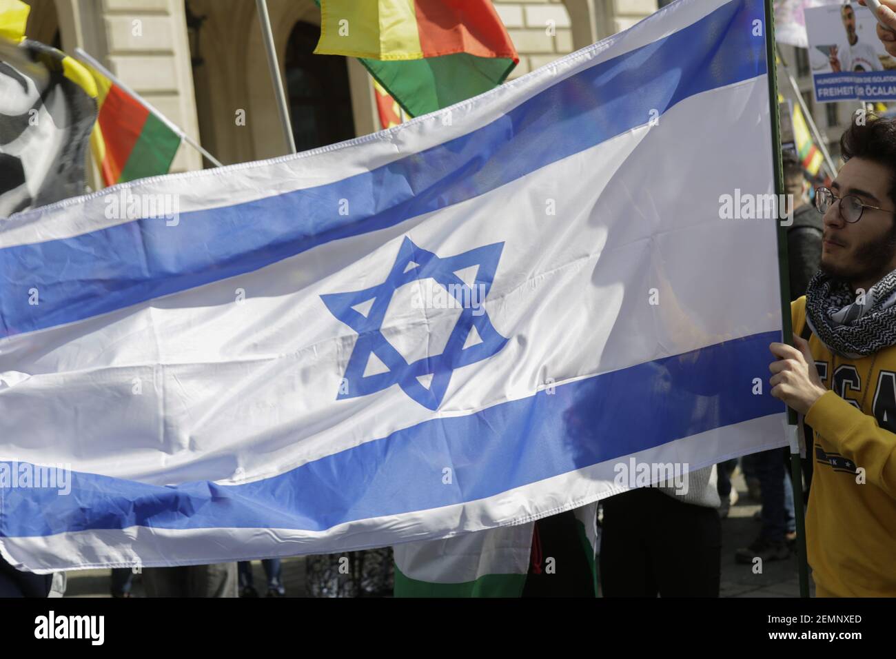 (3/23/2019) A participants waves an Israeli flag at the march. Several ...