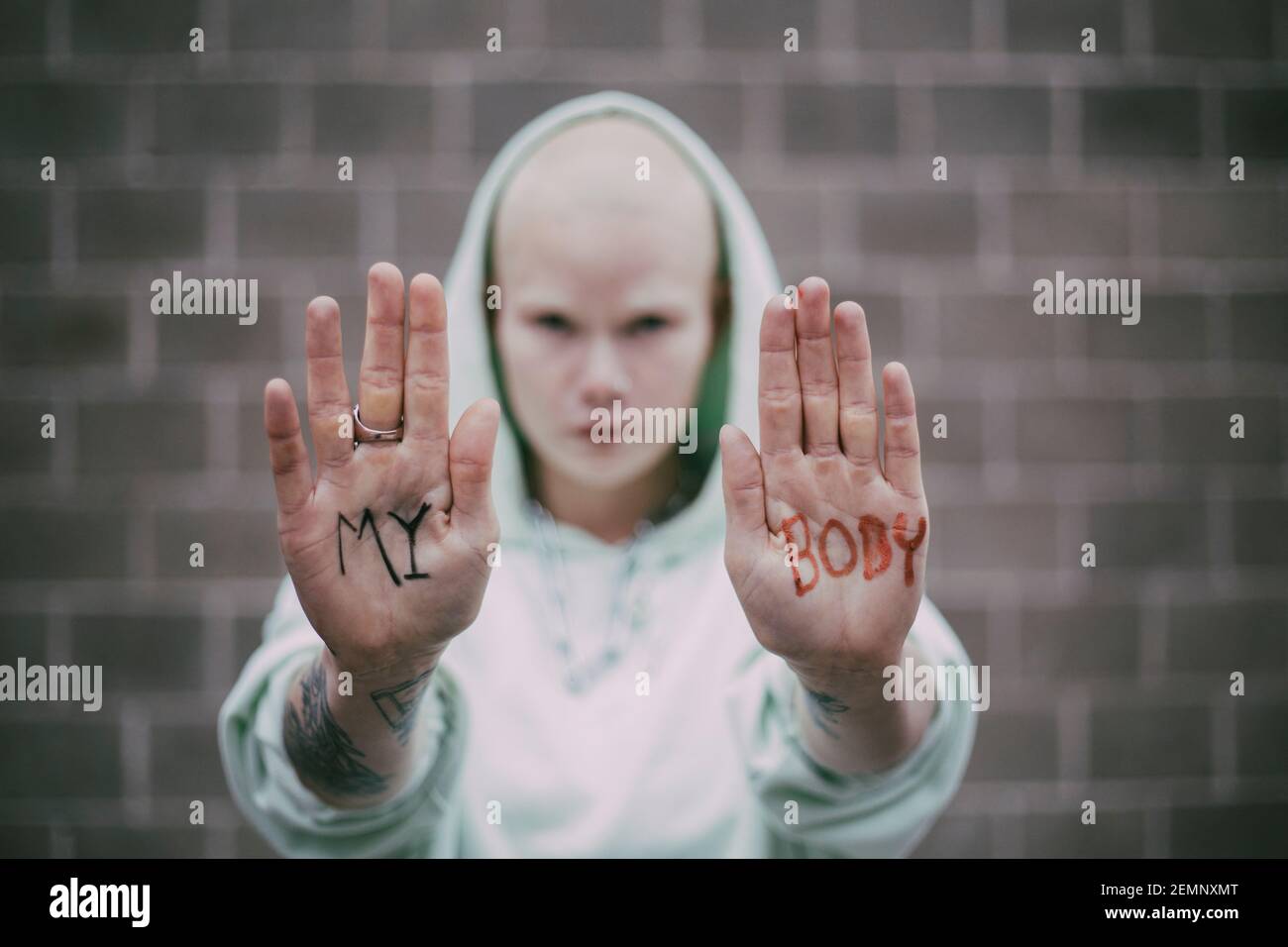 My body text written on palms of female activist Stock Photo - Alamy