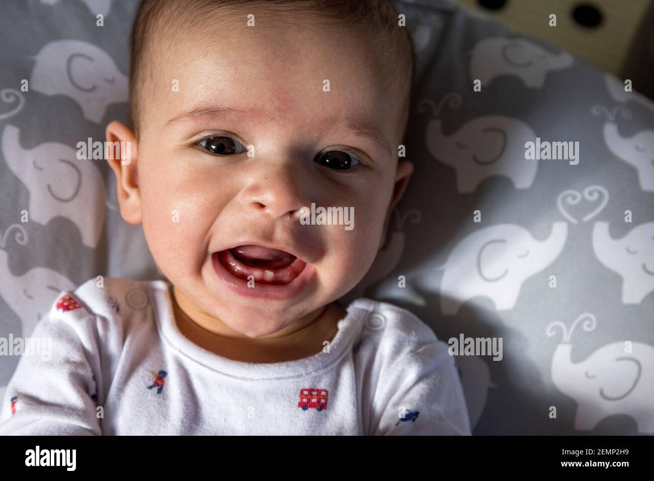 Happy little baby showing teeth Stock Photo - Alamy