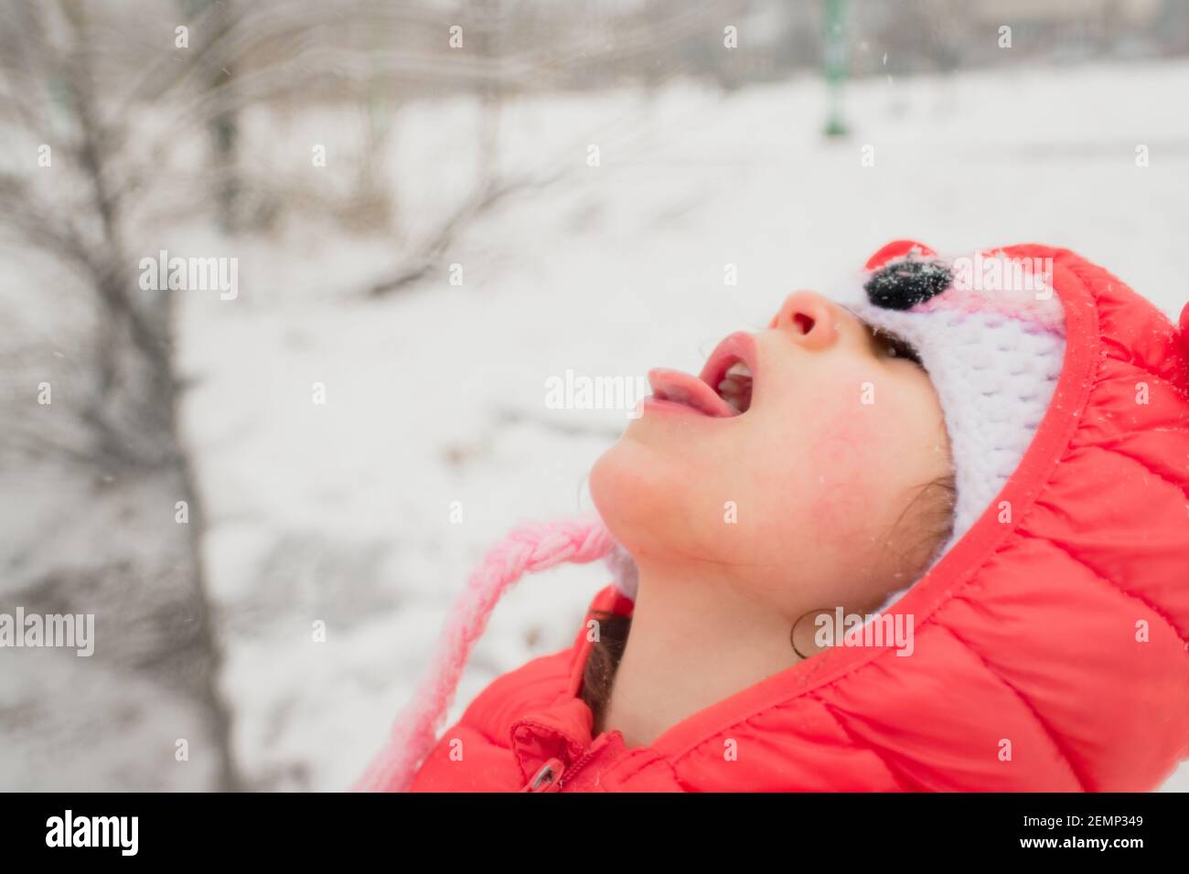 Child catching snowflakes on tongue in blizzard Stock Photo - Alamy
