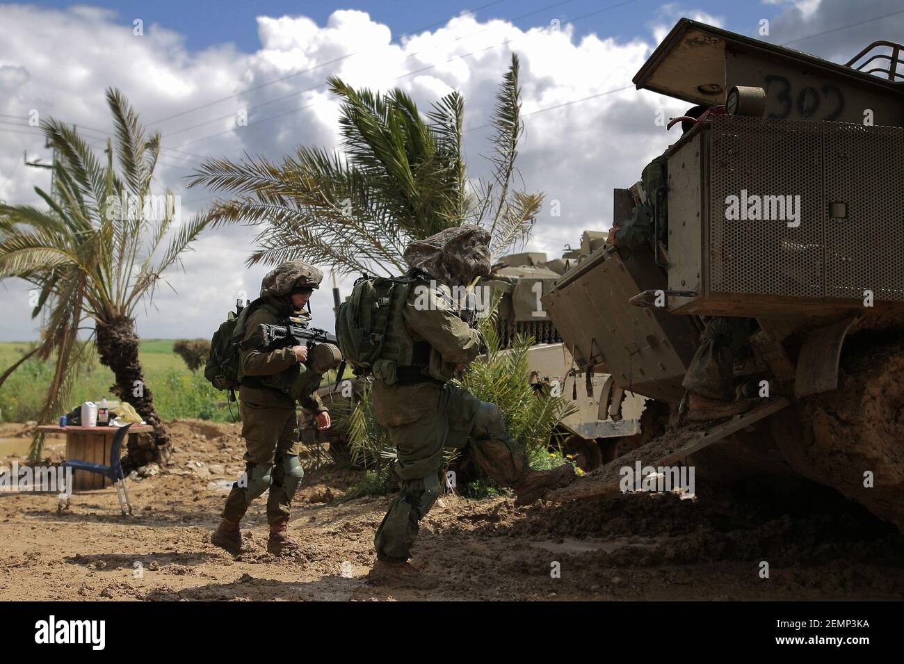 Israeli soldiers stand guard and block the entrance near the border ...