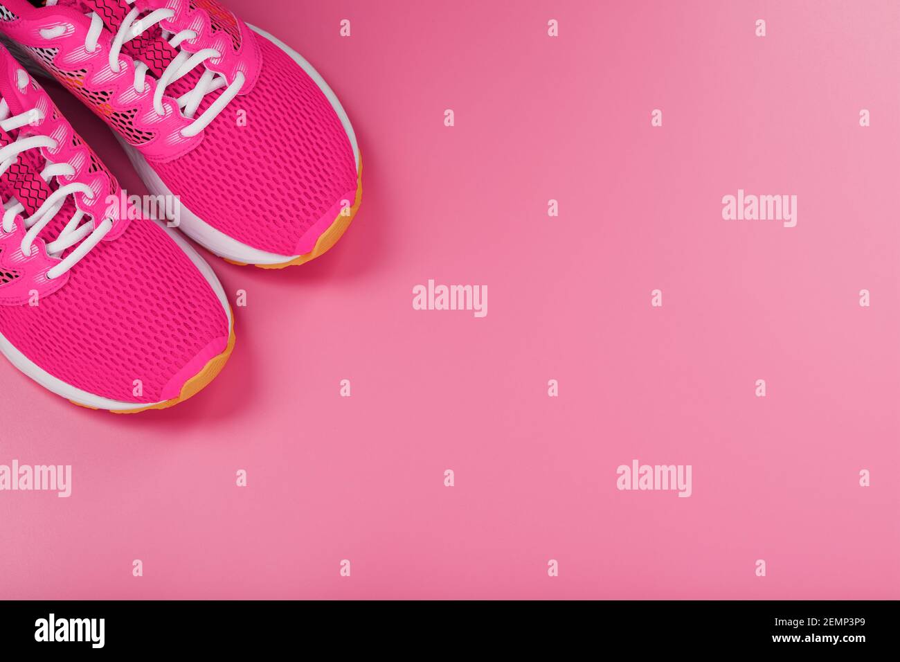 Sports pink sneakers on a pink background with free space. Top view ...