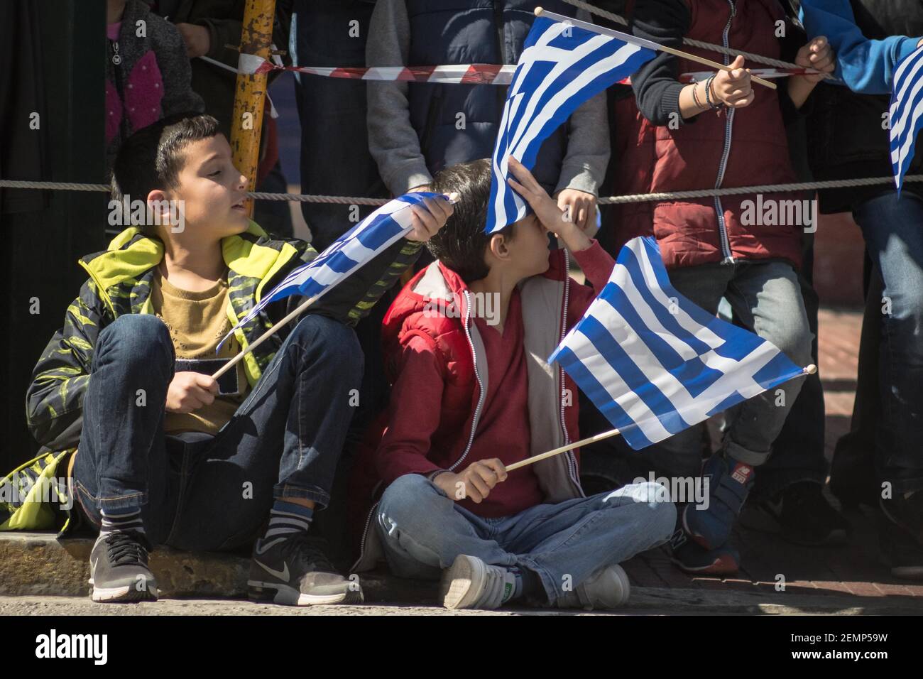 Kids seen holding Greek flags during the celebration. Military parades ...
