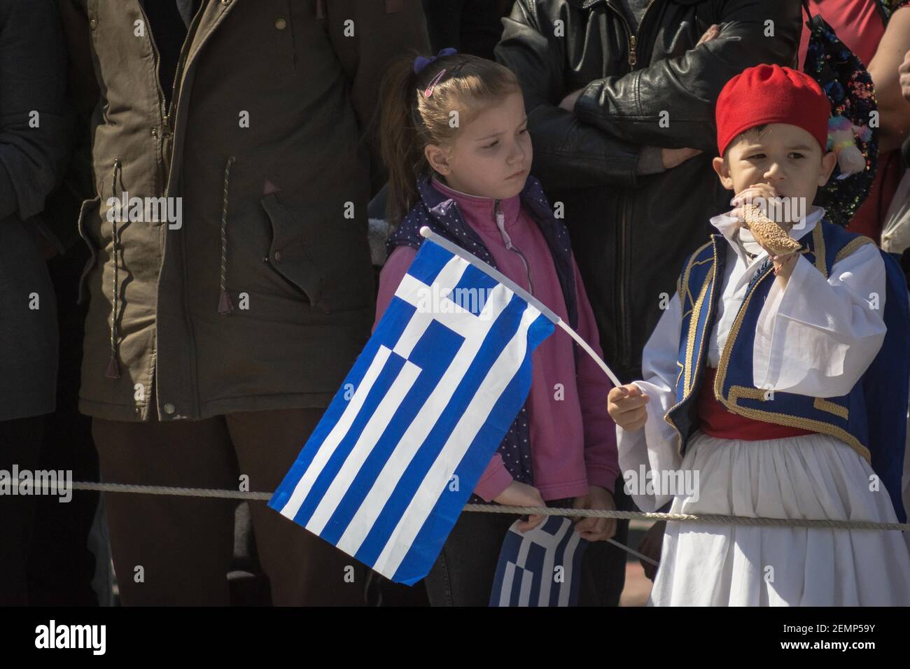 A kid seen in a traditional costume holding Greek flag during the ...