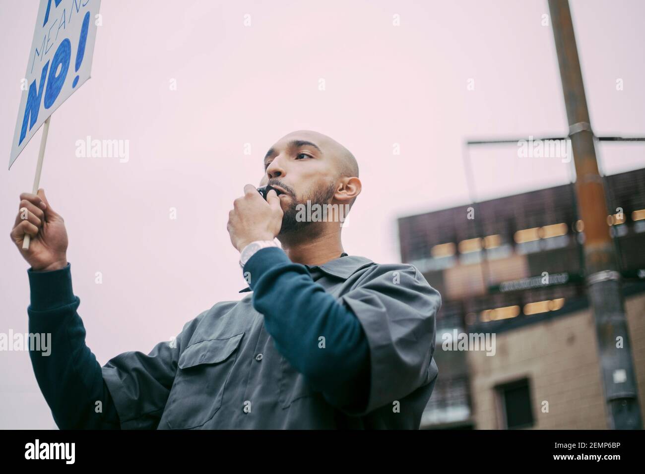 Male activist holding no means no poster during social movement Stock ...