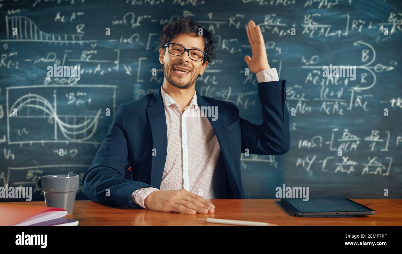 E-Education Concept: Teacher Sitting at Desk, Explains Lesson to a ...