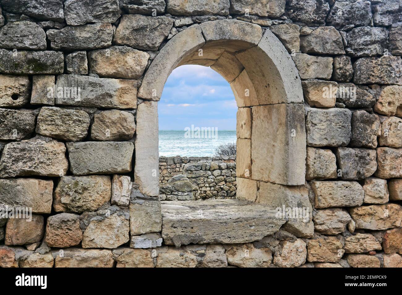semicircular window opening in the ruins of an antique wall, behind ...