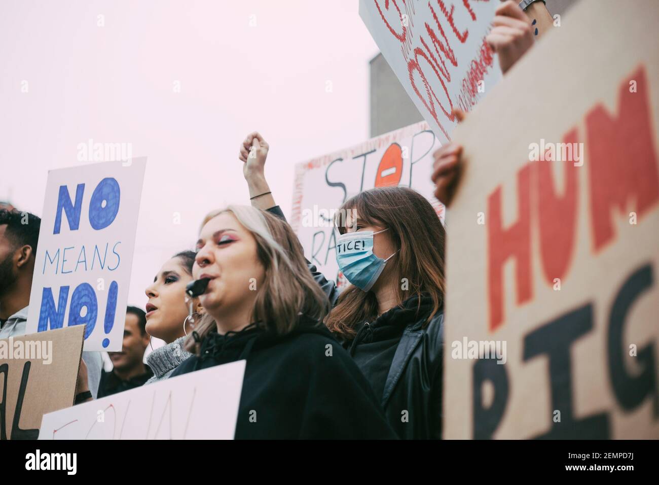 Female activist participating in anti-racism protest during COVID-19 ...