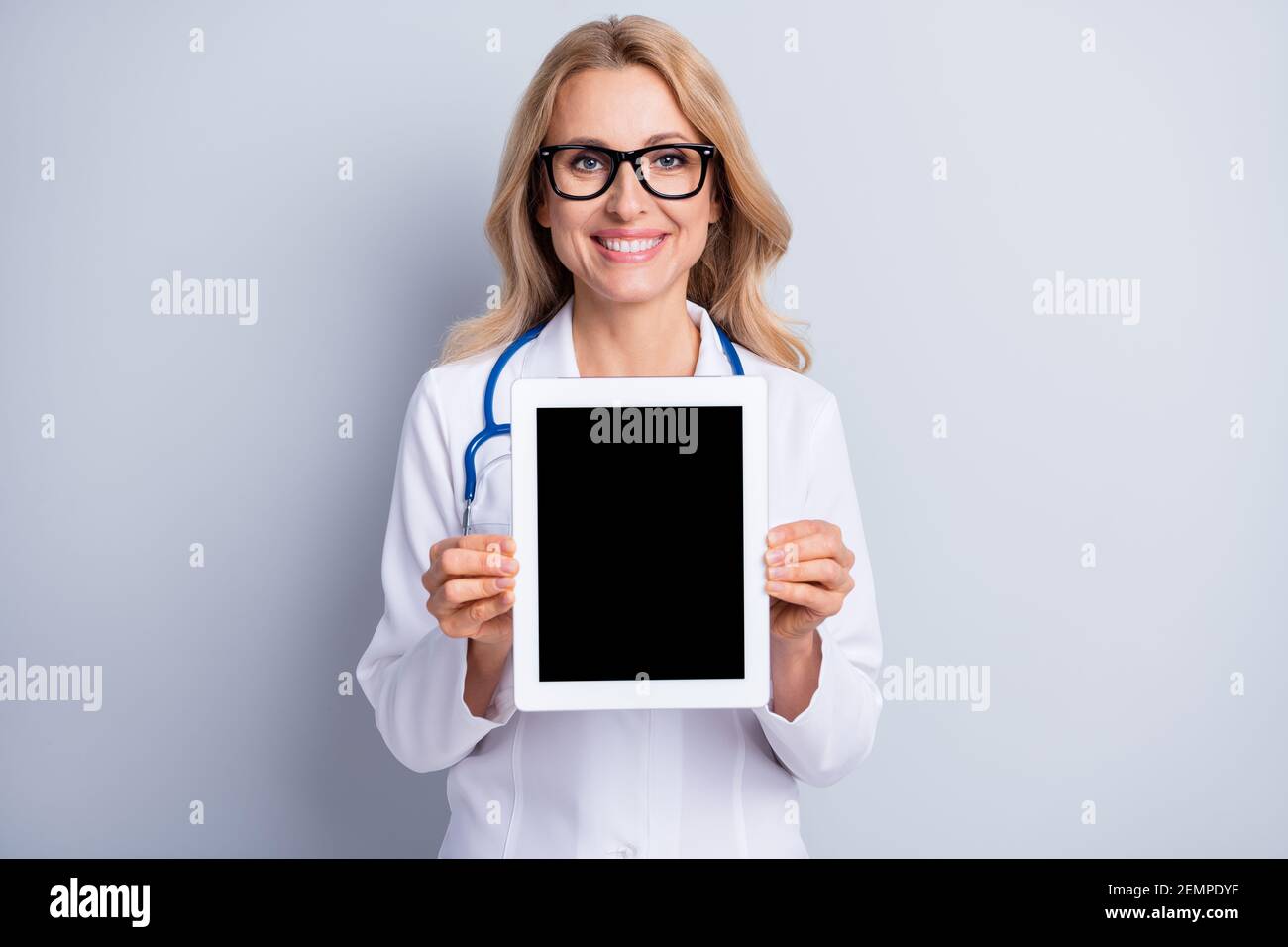 Portrait of attractive positive lady hands hold tablet demonstrate ...
