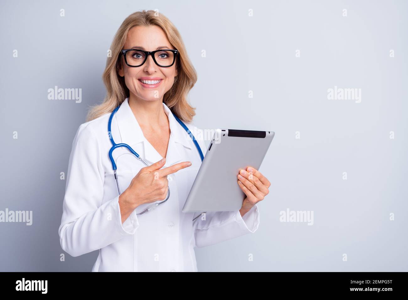 Photo of pretty positive lady indicate finger tablet wear spectacles ...