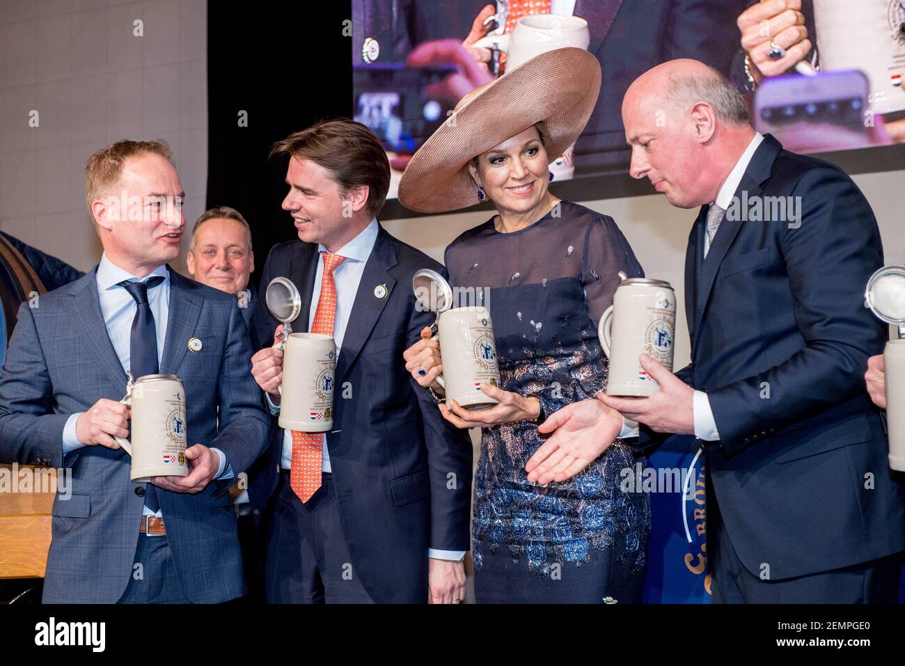 Queen Maxima drinks beer from a giant beer mug during the start of the ...