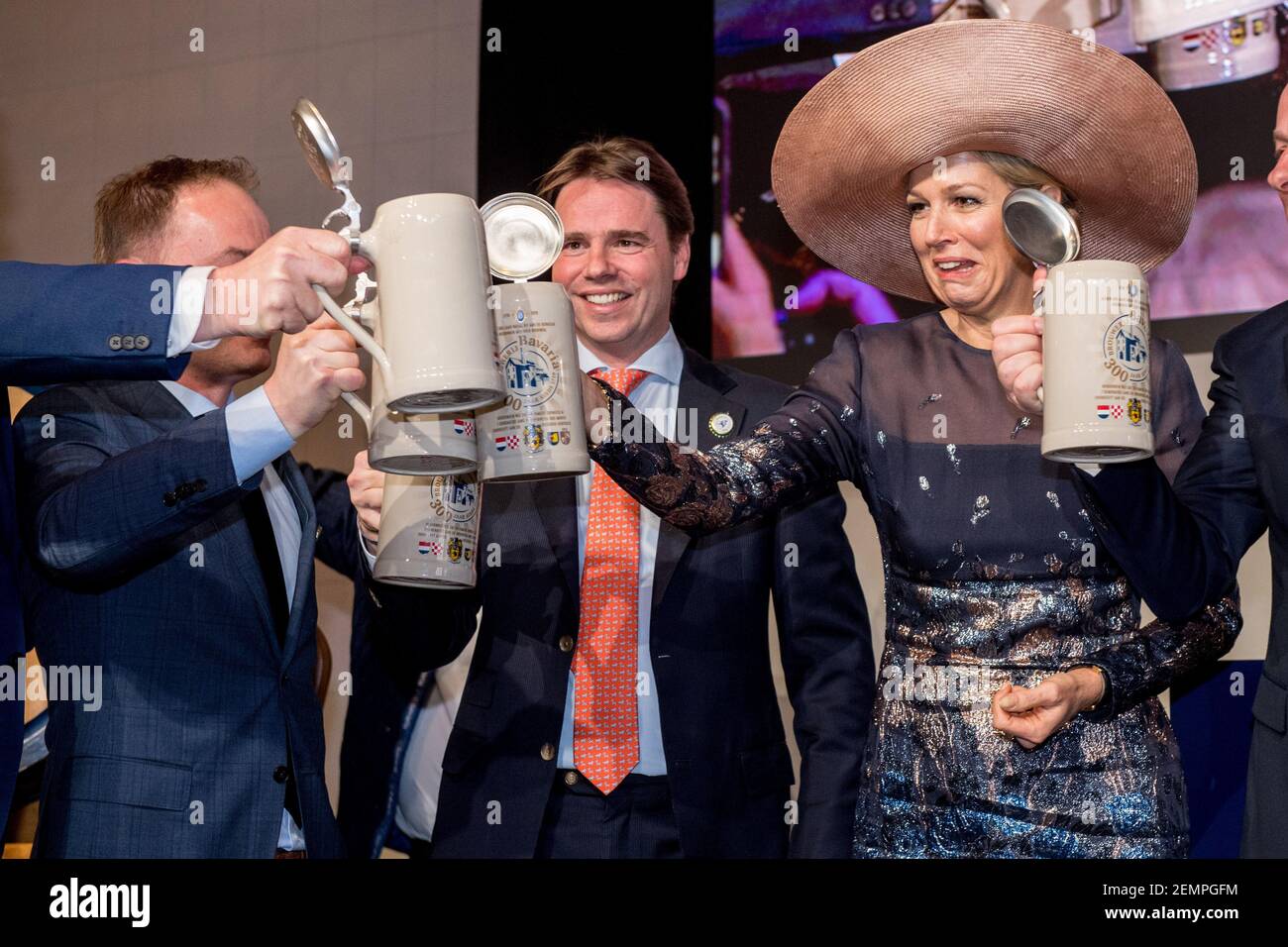 Queen Maxima drinks beer from a giant beer mug during the start of the ...