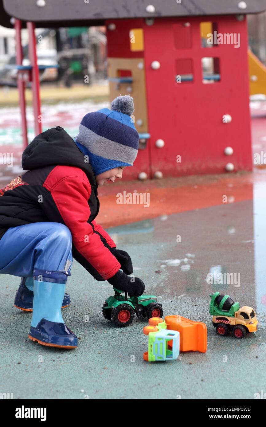 Boy playing on the playground in spring Stock Photo - Alamy