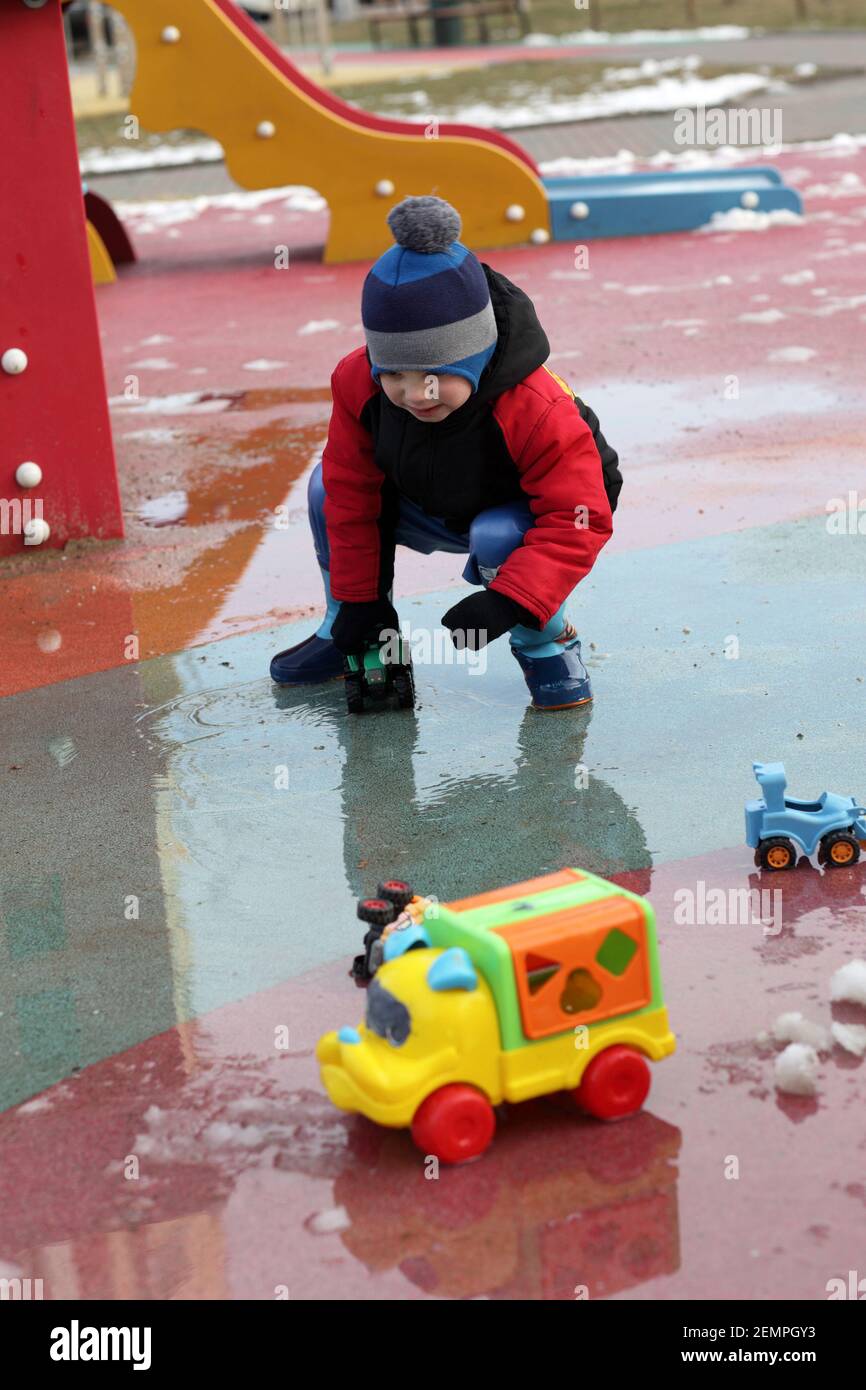Kid playing with toy cars at outdoor playground in spring Stock Photo ...