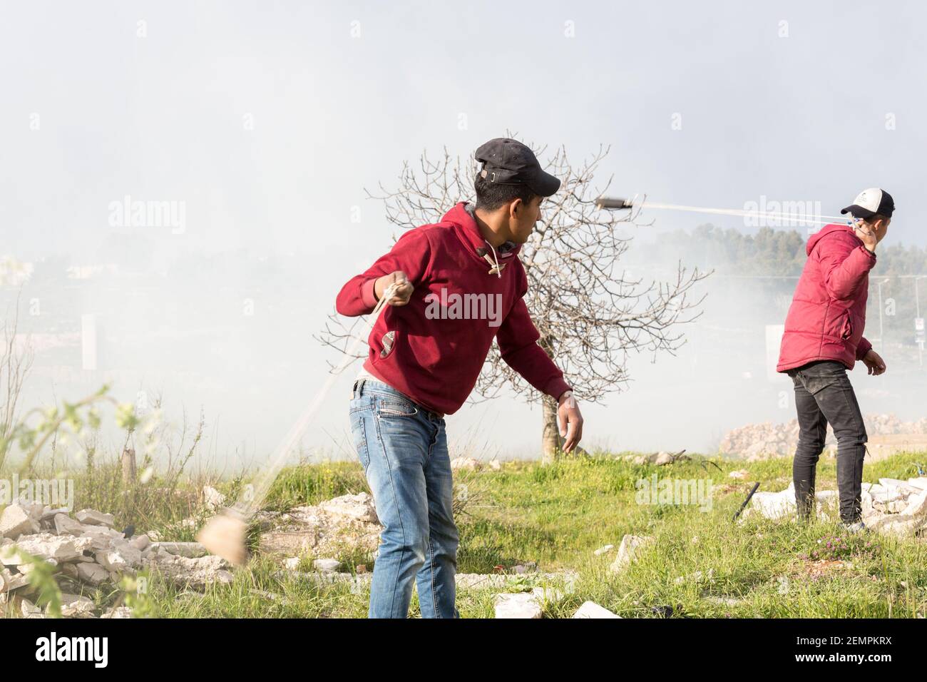 Palestinian use sling to throws a stones during clashes with Israeli ...