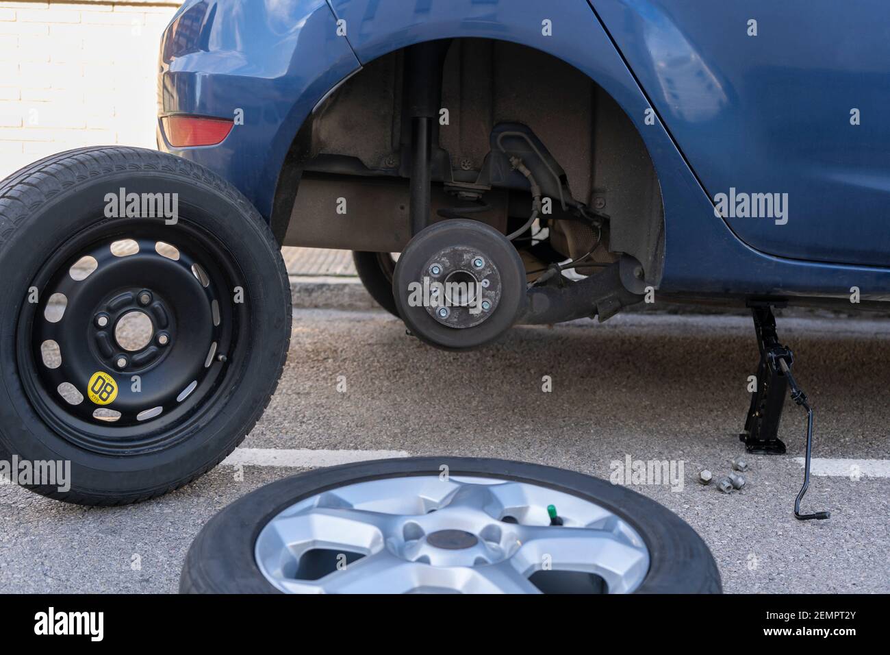Replacing car wheels and tires concept.Jack holds the car without wheel ...