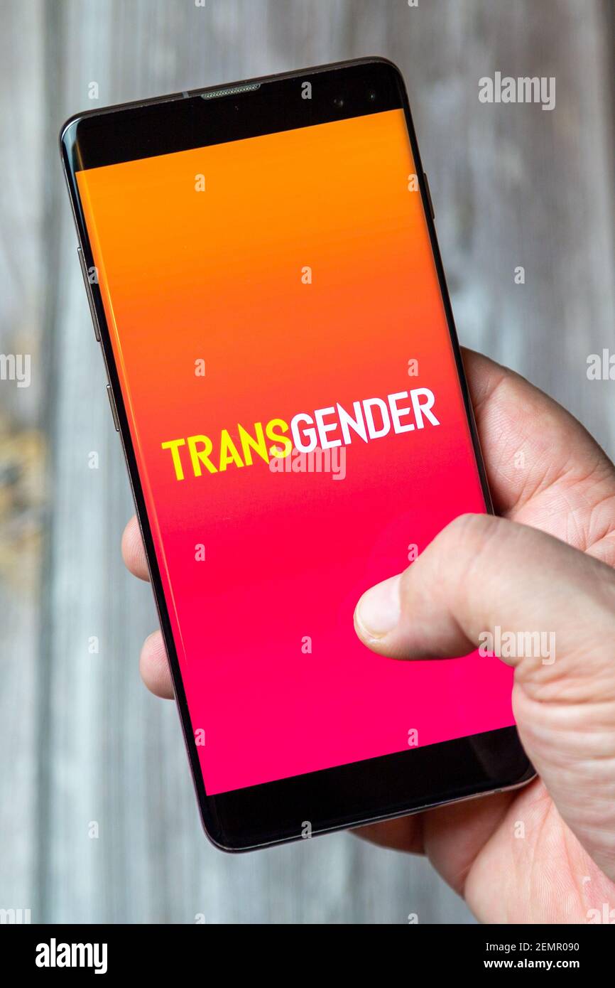 A mobile phone or cell phone being held by a hand with the Transgender ...