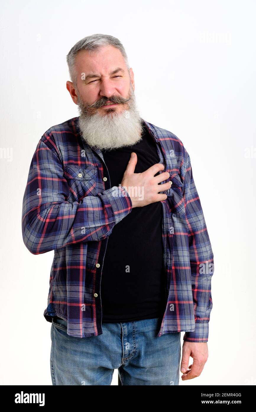 Mature caucasian man dressed in casual clothes feels bad, holding hand ...