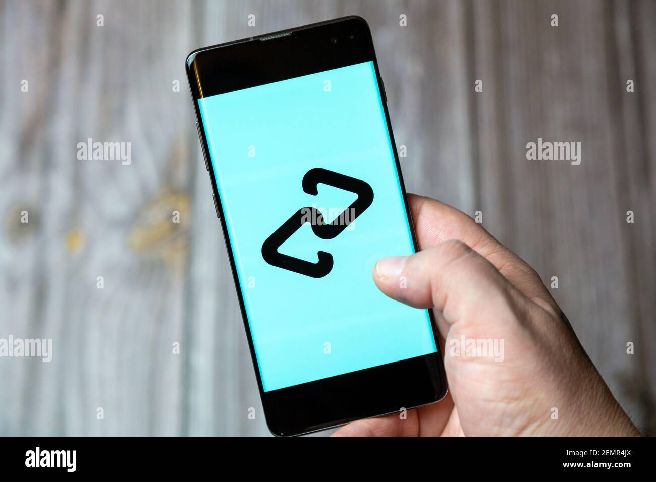 A mobile phone or cell phone being held by a hand with the Clear pay ...