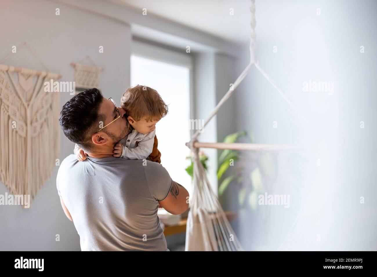 Father looking after his small son at home Stock Photo - Alamy