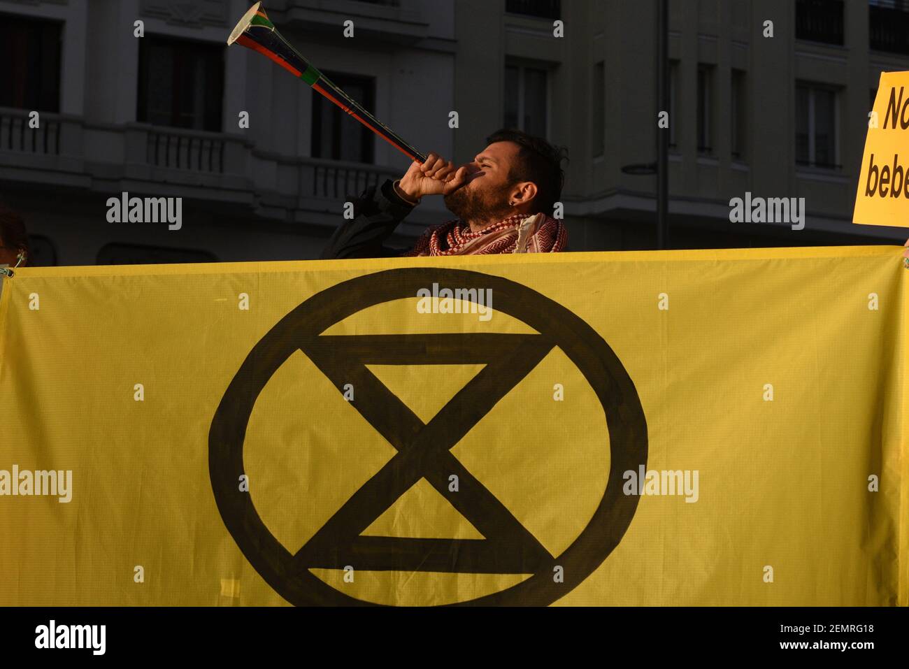 A man is seen making noise during the protest. Activists from group ...