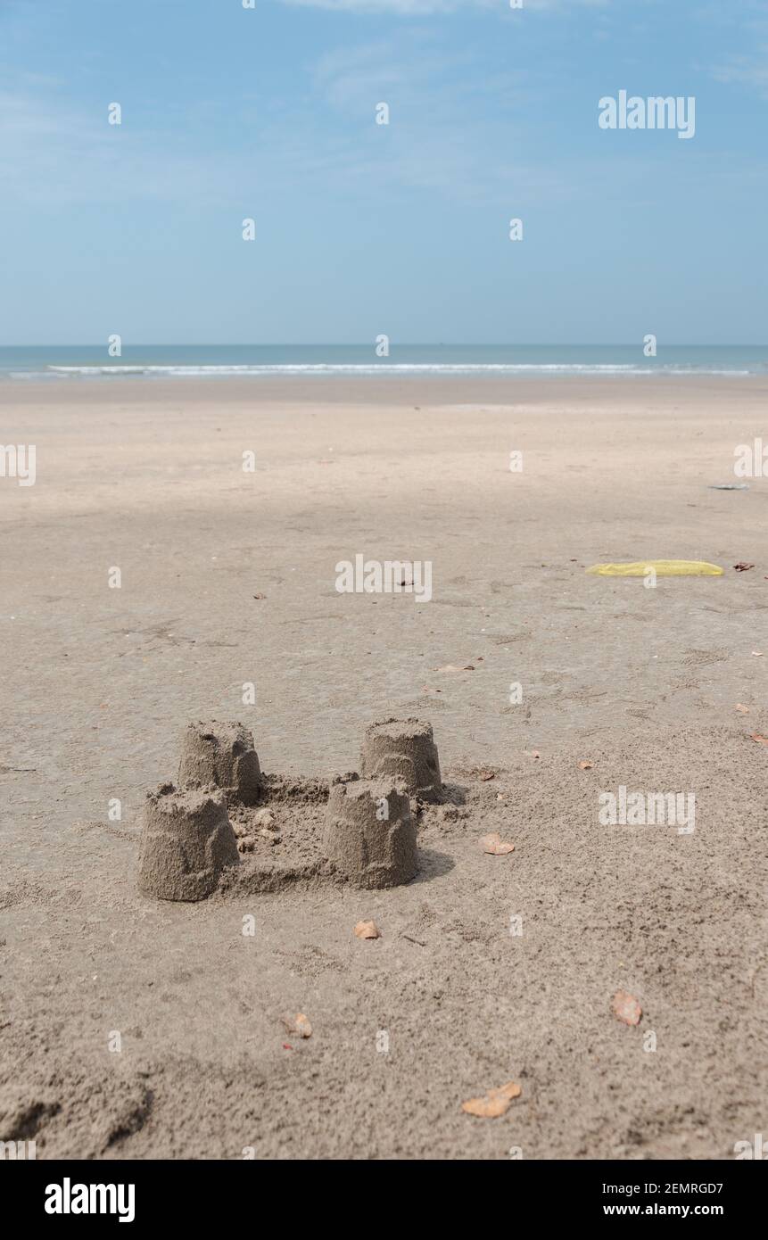 Close-up of a tiny sand castle on clean and empty Ashvem Beach in Goa ...