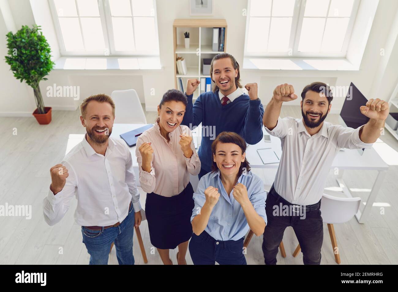 Overjoyed Sales Department Team cheering in work meeting after ...