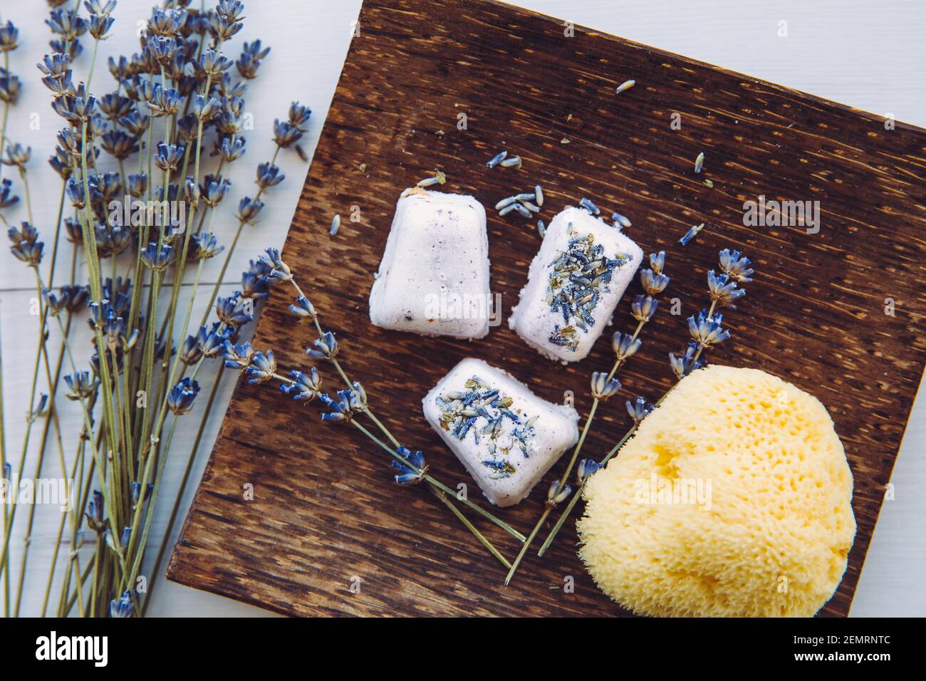 Flat lay view of small cube shape bathroom bath fizzies on wood tray ...