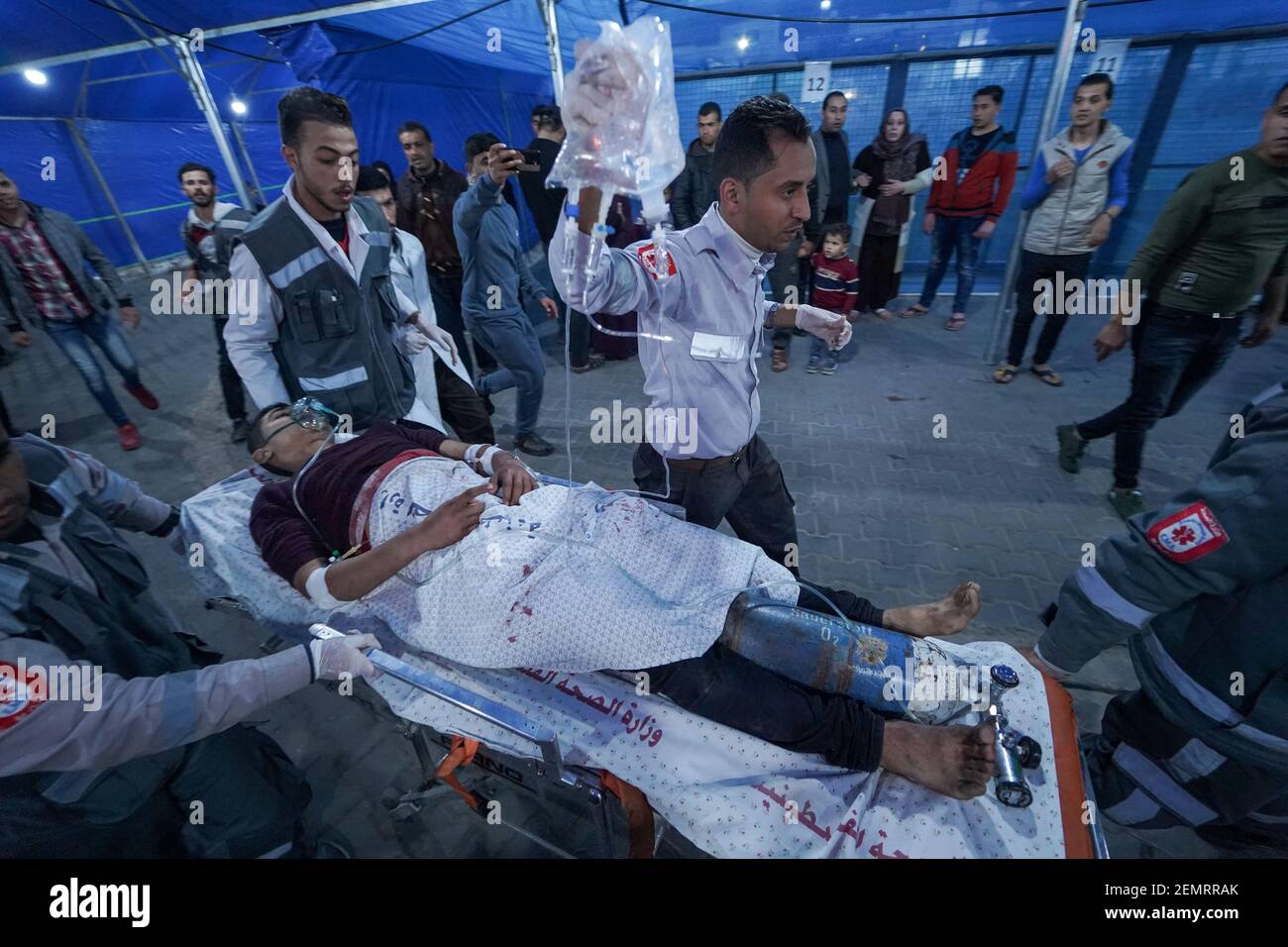 Palestinian medics are seen rolling a wounded child to receive ...