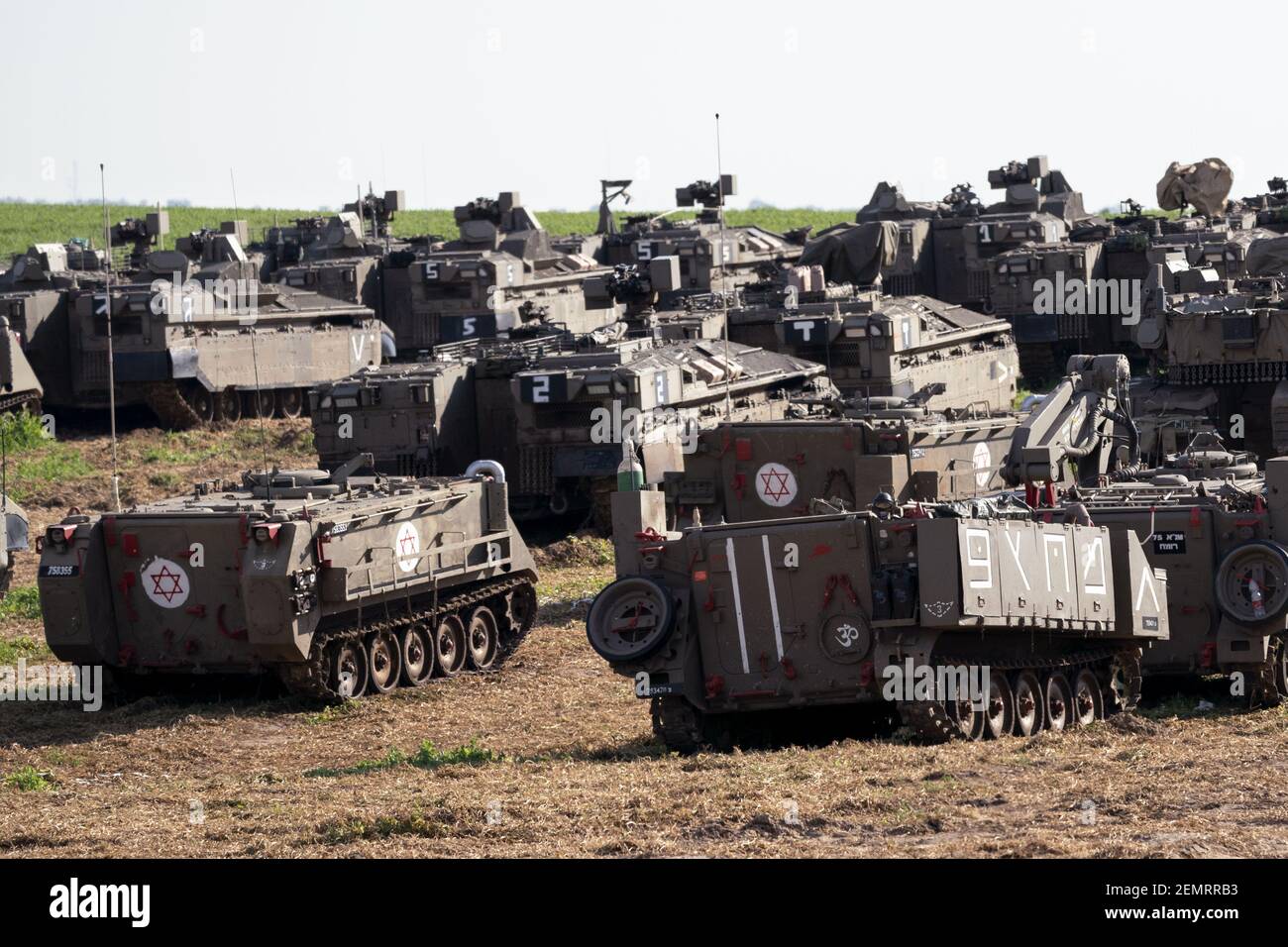 Israeli military vehicles and tanks positioned near the border with the ...