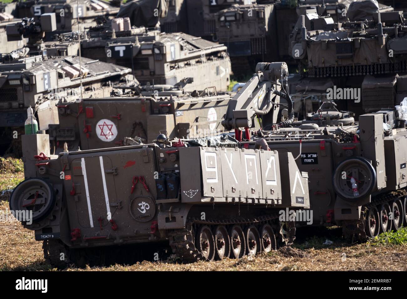 Israeli military vehicles and tanks positioned near the border with the ...