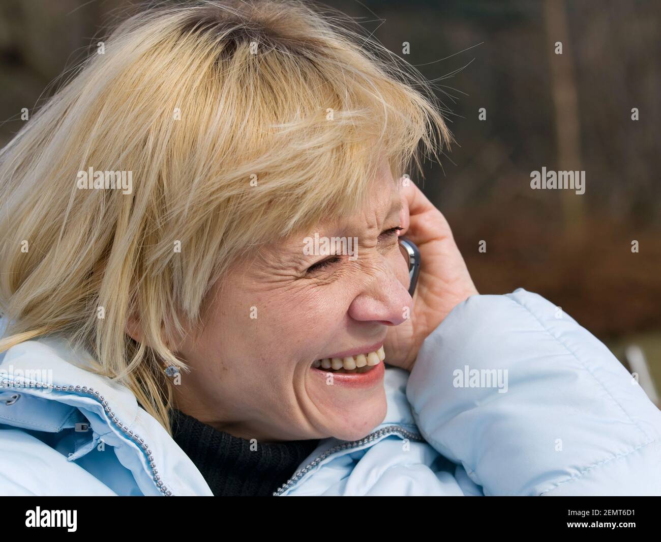 Mature lady having fun during making phone call Stock Photo - Alamy
