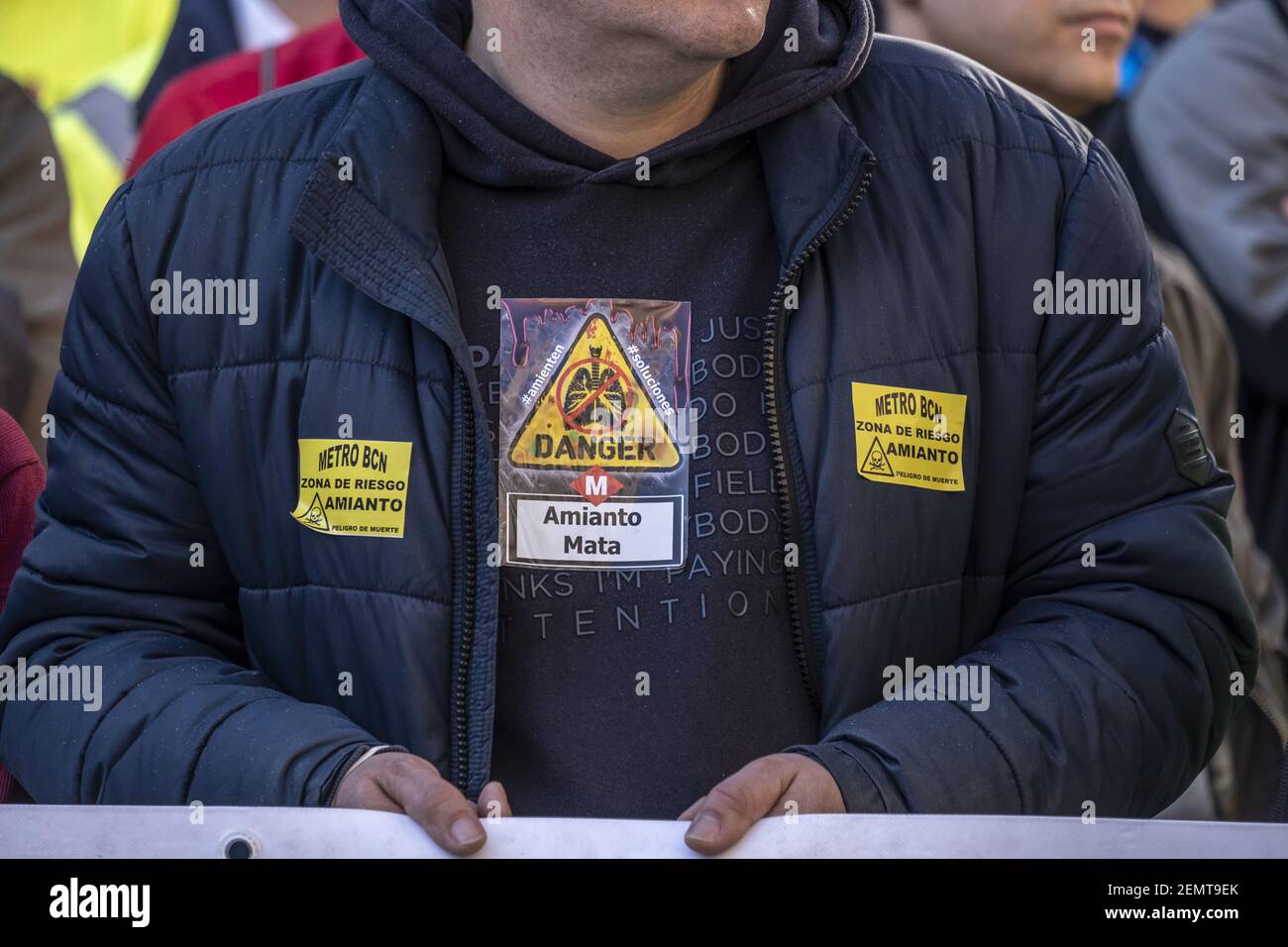 A subway worker is seen with stickers denouncing asbestos during the ...