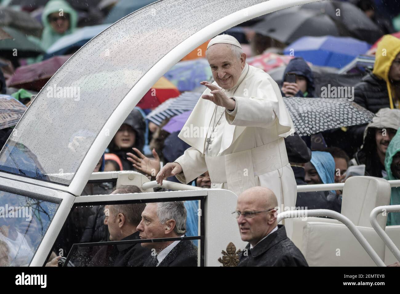 Pope Francis rides on the Popemobile through the crowd of the faithful ...