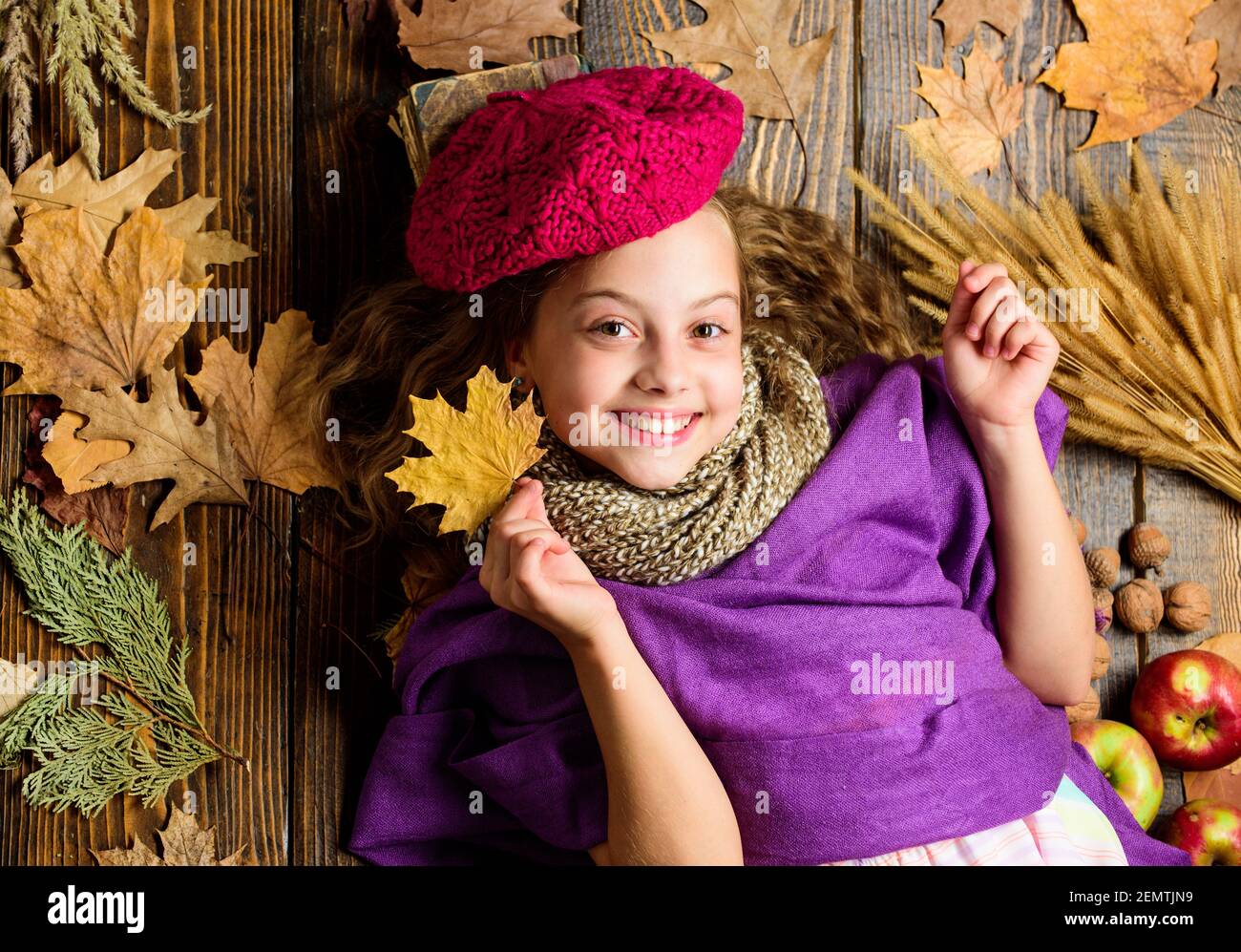 Knitted hat trend fall season. Girl lay wooden background fallen leaves ...