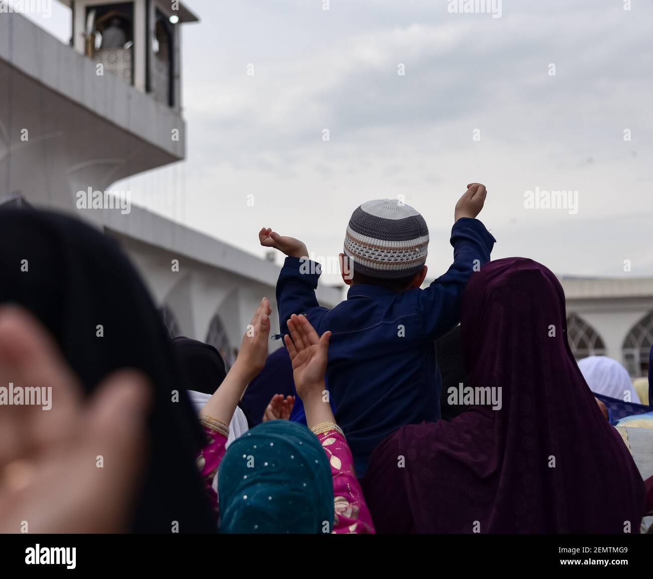 A Kashmiri Muslim boy seen raising hands while beseeching for blessings ...