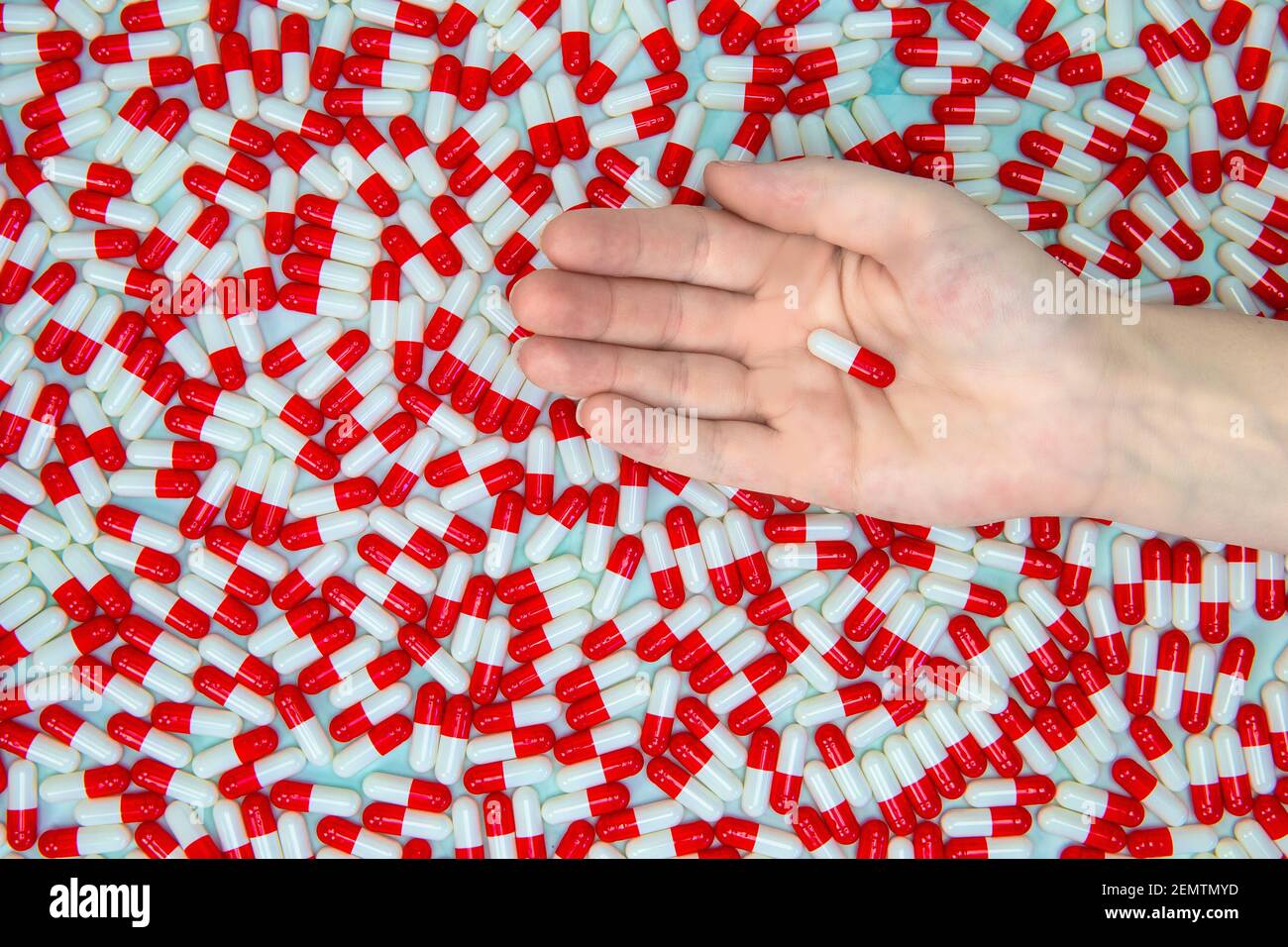 hands holding red and white capsules for medication, vitamin or drugs ...