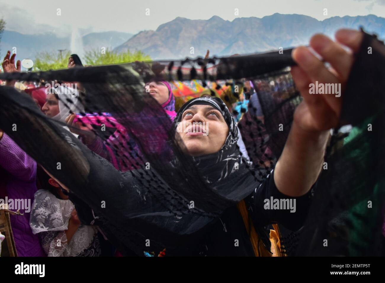 A devotee seen praying upon seeing a relic believed to be hair from the ...