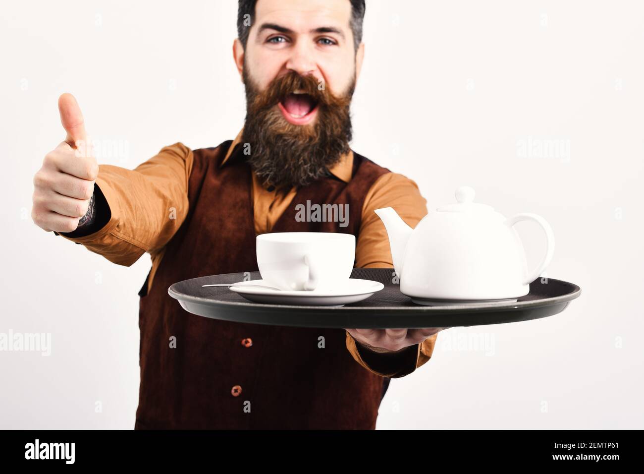 Waiter with white tea cup and pot on tray. Restaurant catering concept ...