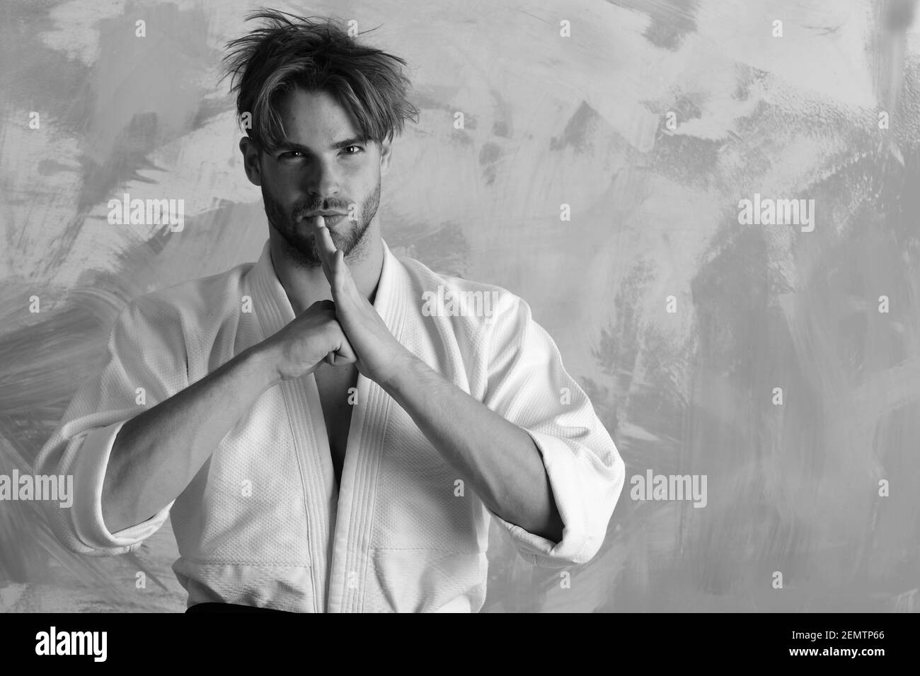 Japanese karate concept. Guy poses in white kimono. Man with confident ...
