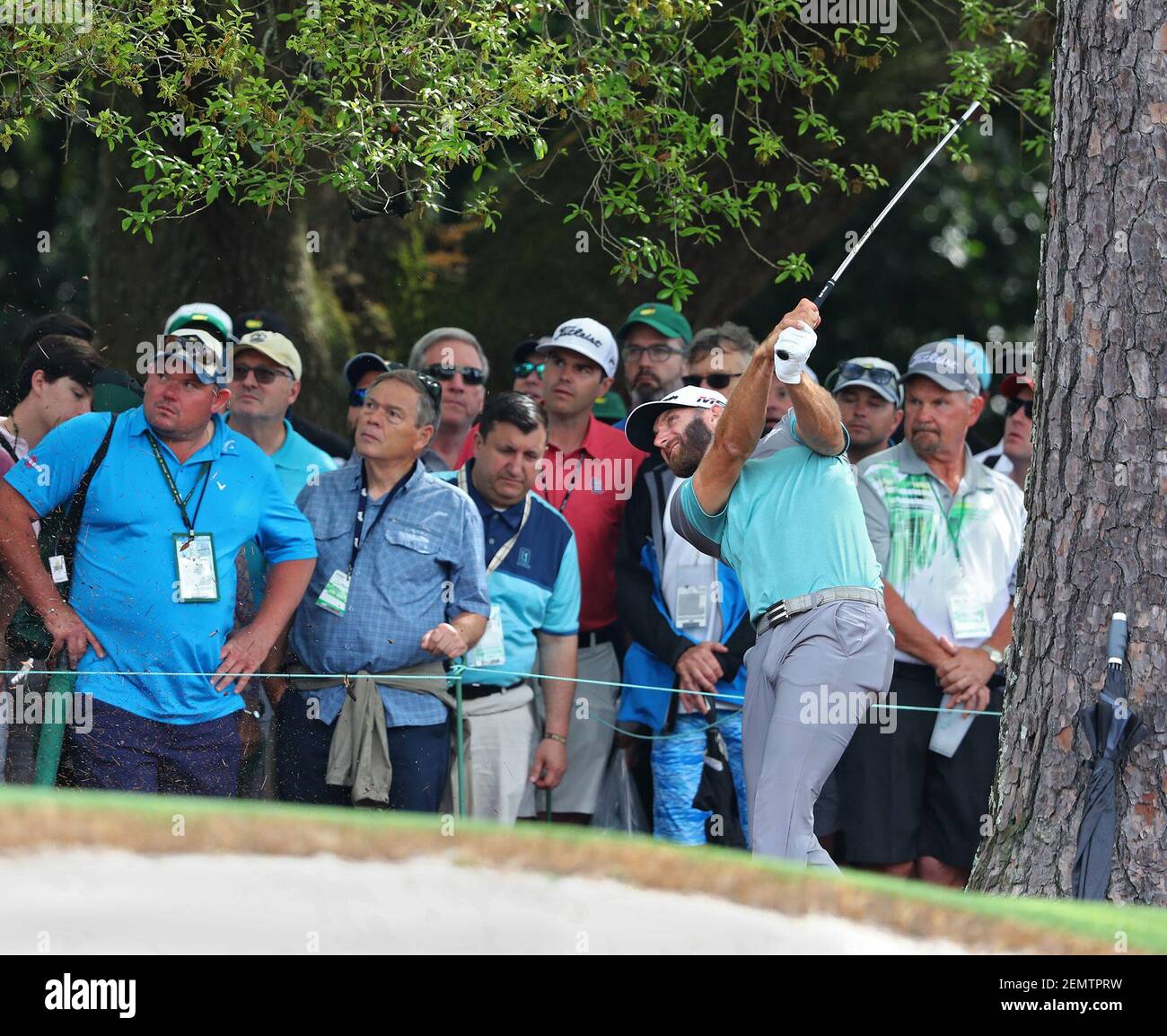 Dustin Johnson hits out of the trees on the 1st hole during the second ...